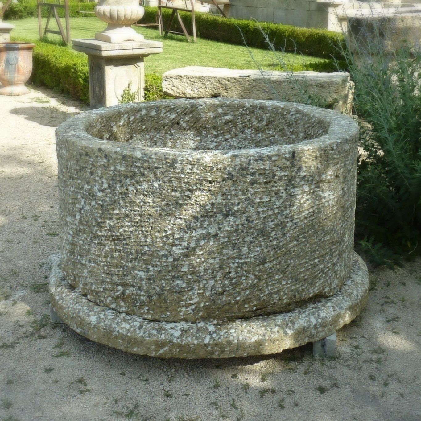 Large round trough in patinated stone ideal for a garden flower pot